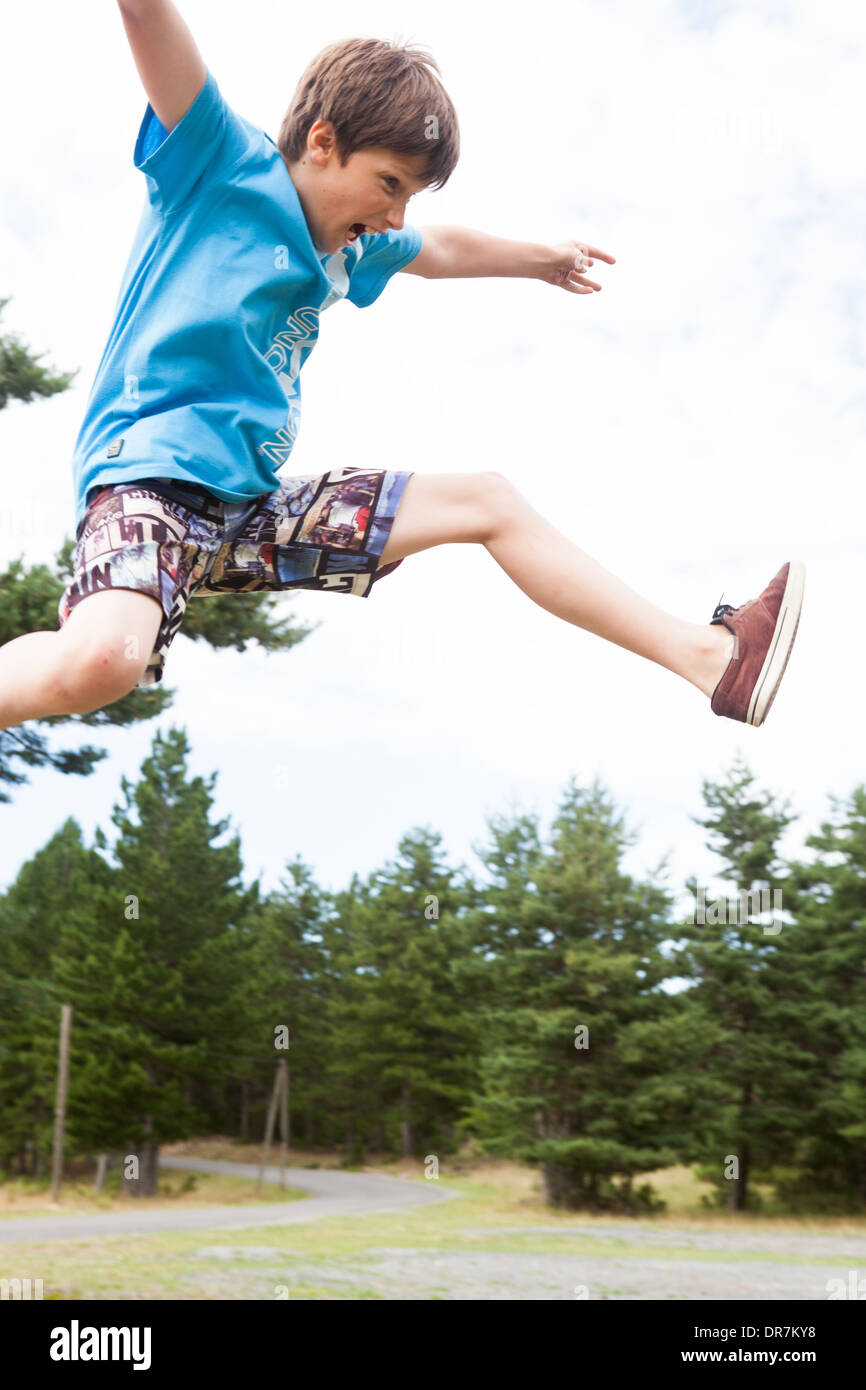 boy jumping, joy, leaping, trees, forest Stock Photo - Alamy