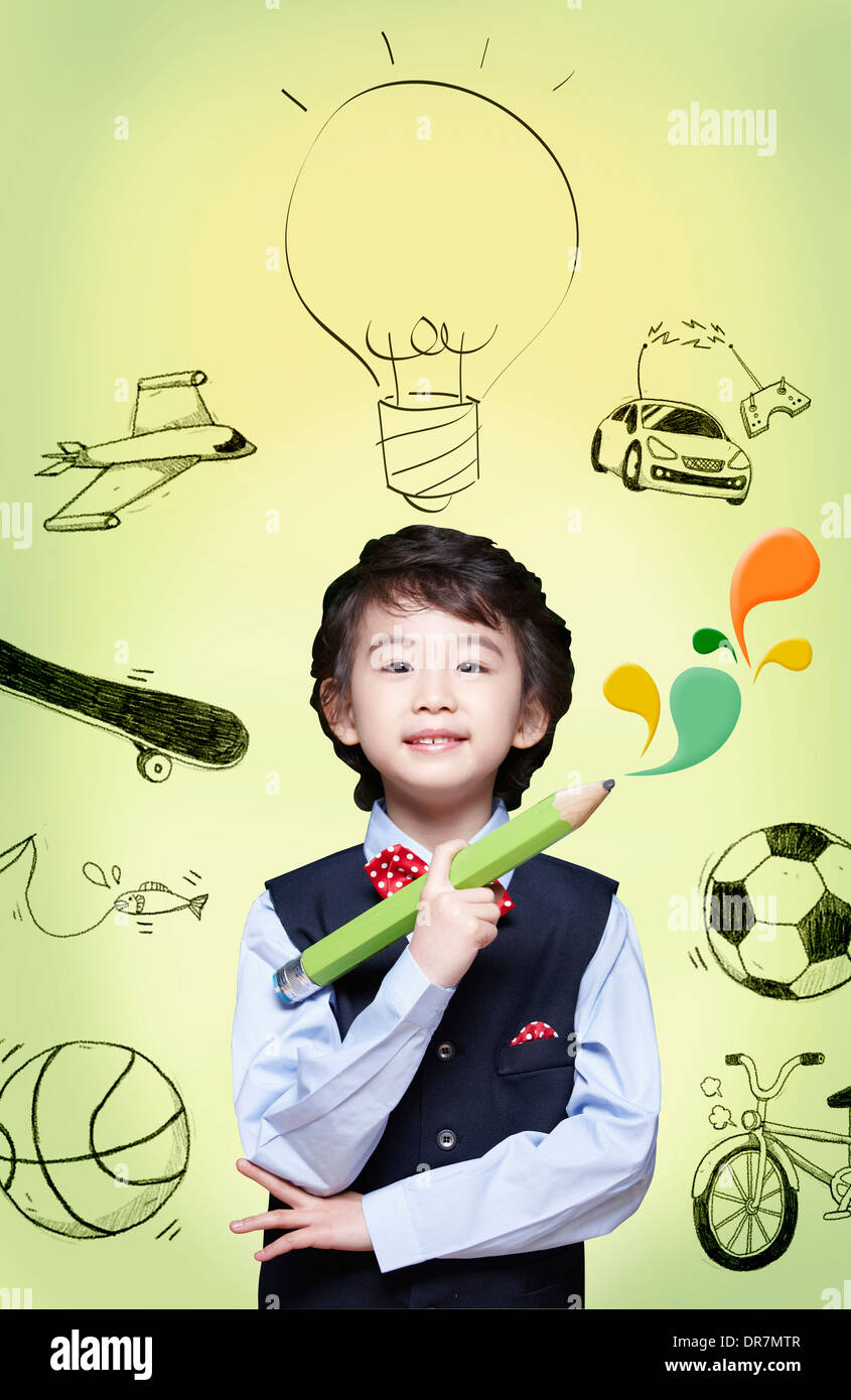 a kid holding a pencil Stock Photo - Alamy