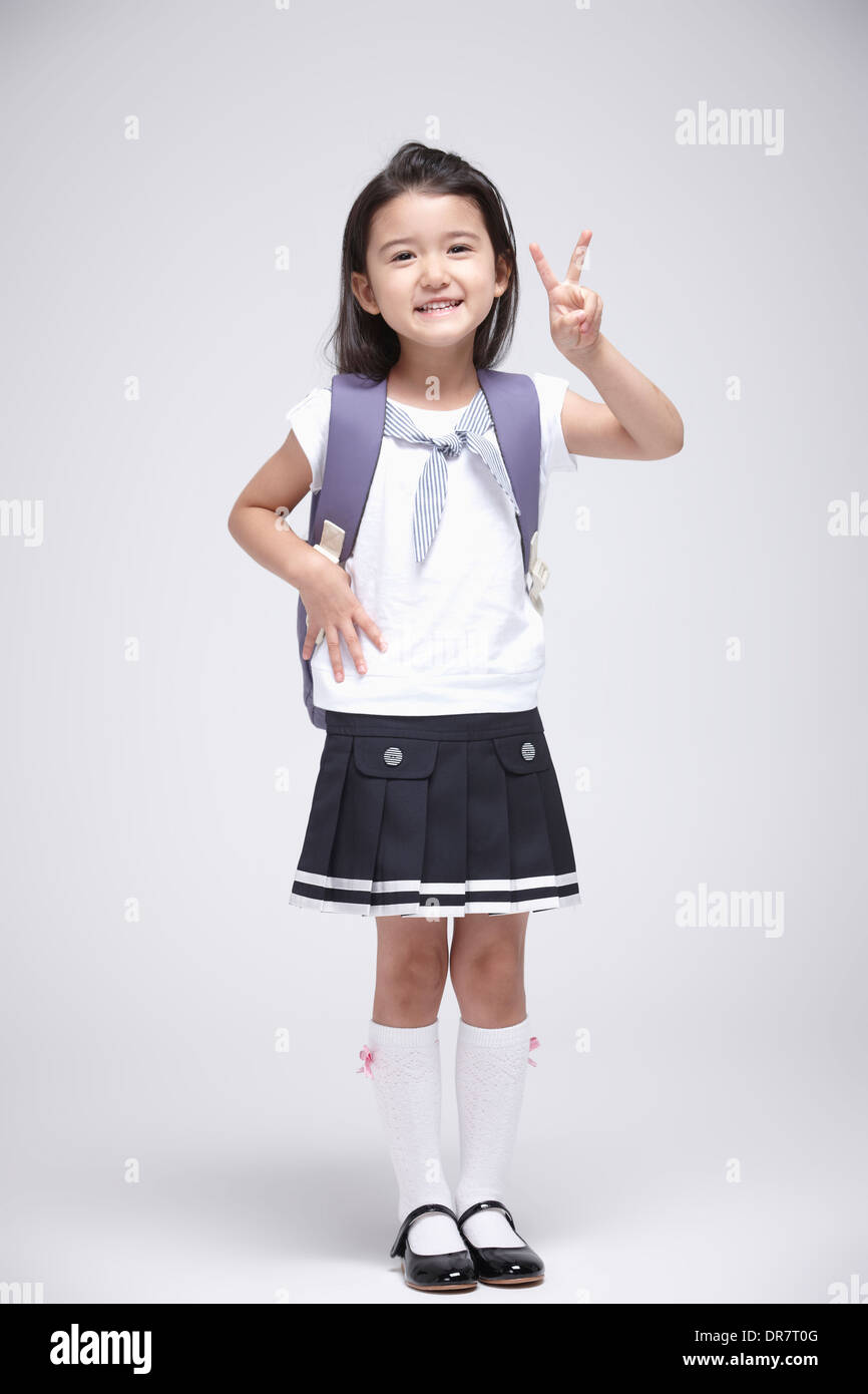a girl wearing a school bag posing in white background Stock Photo - Alamy