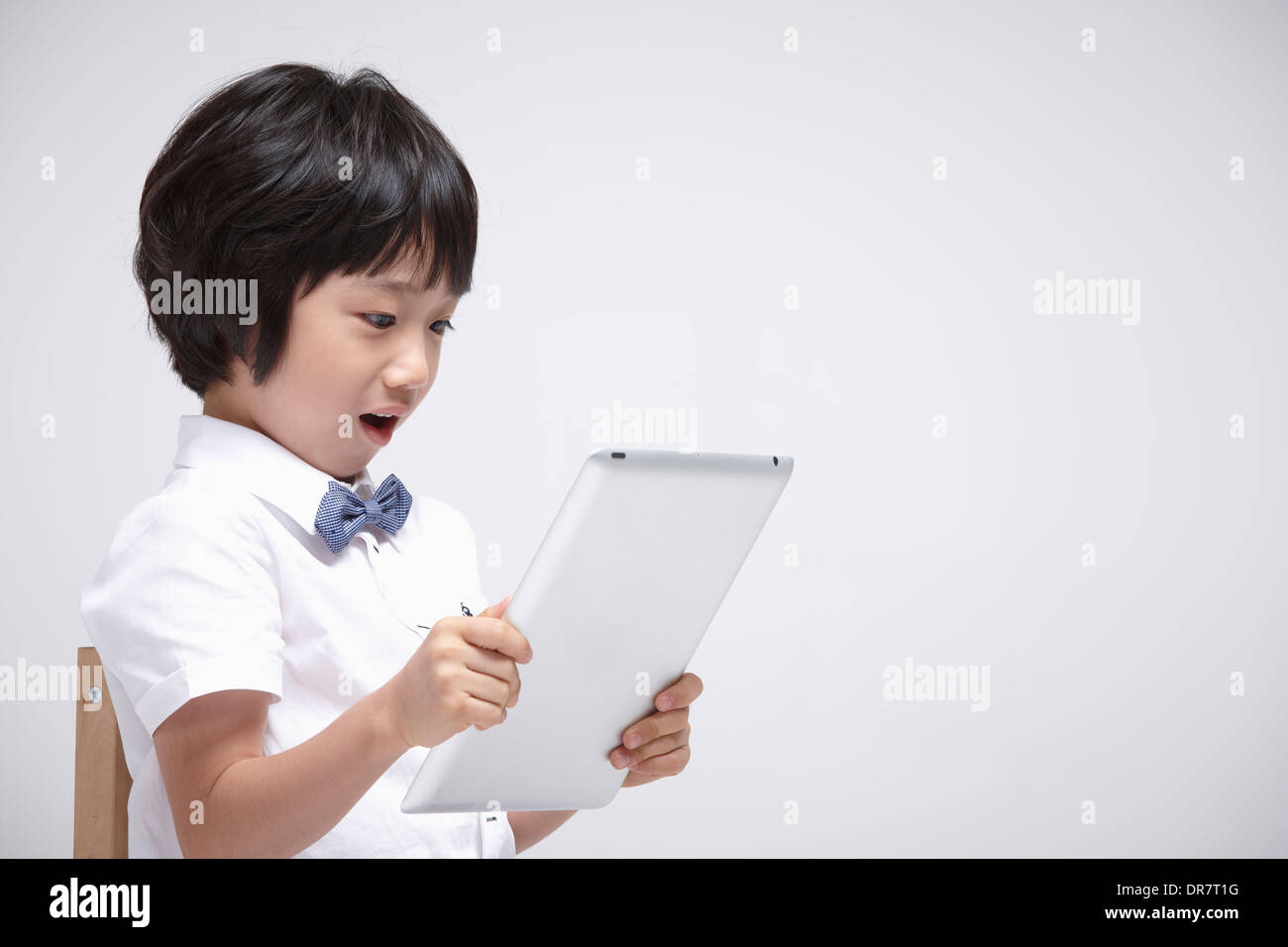 Boy tablet pc sitting hi-res stock photography and images - Alamy