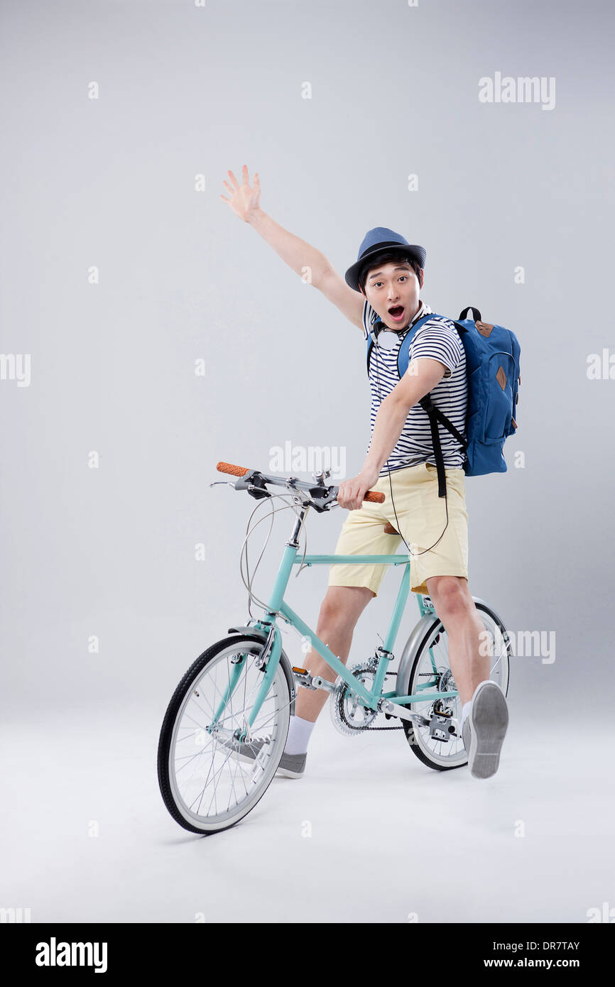 Man riding bike waving hi-res stock photography and images - Alamy