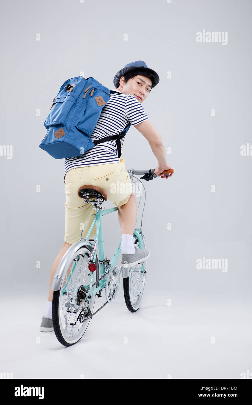 back shot of a man riding a bike Stock Photo - Alamy