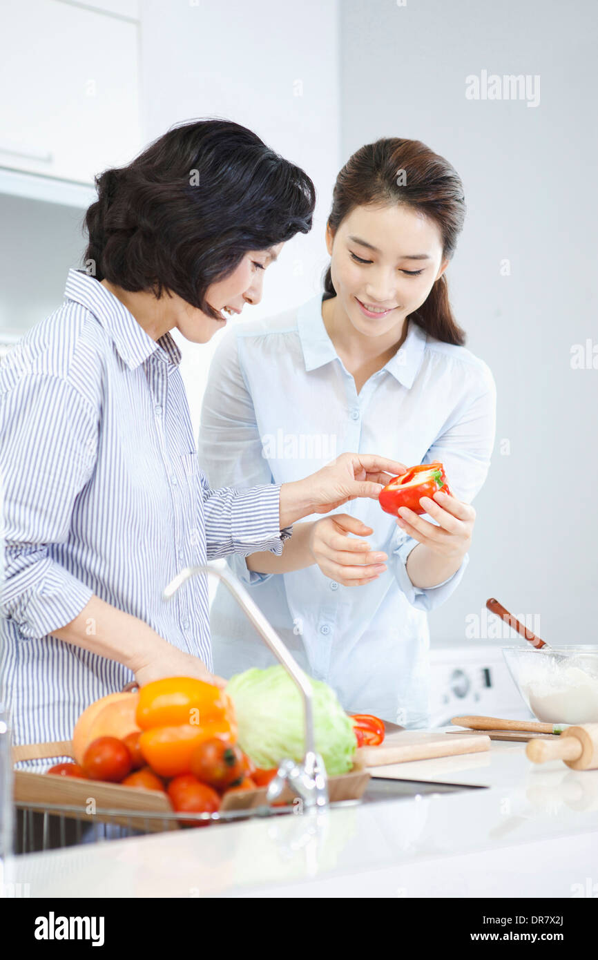 two women cooking in the kitchen Stock Photo - Alamy
