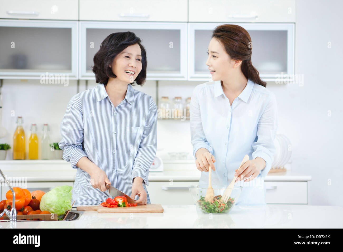 two women cooking in the kitchen Stock Photo - Alamy