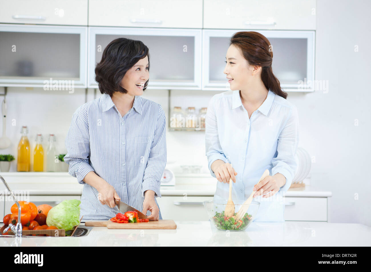 two women cooking in the kitchen Stock Photo - Alamy