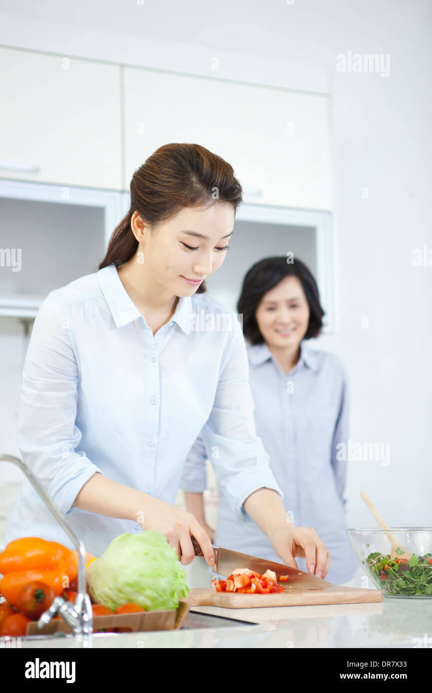 two woman cooking in the kitchen Stock Photo - Alamy