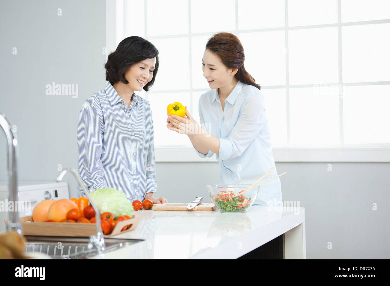 two woman cooking in the kitchen Stock Photo - Alamy