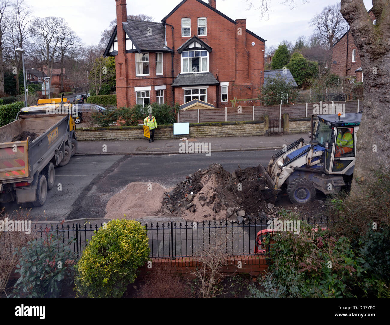 a vehicle picks up rubble to unload into a waiting lorry. The rubble ...
