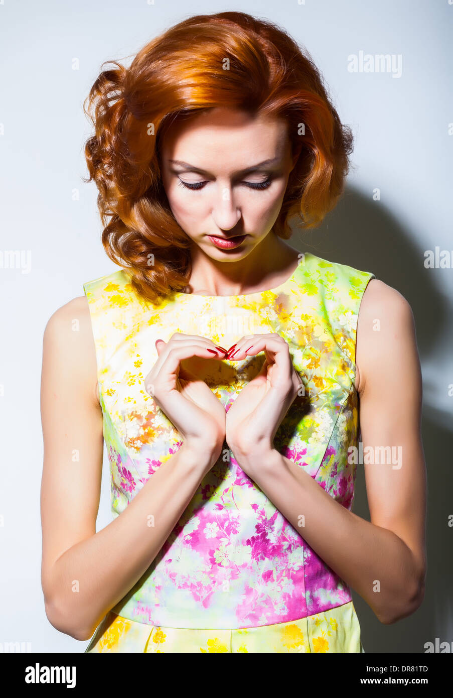 Girl making sign heart by hands Stock Photo - Alamy