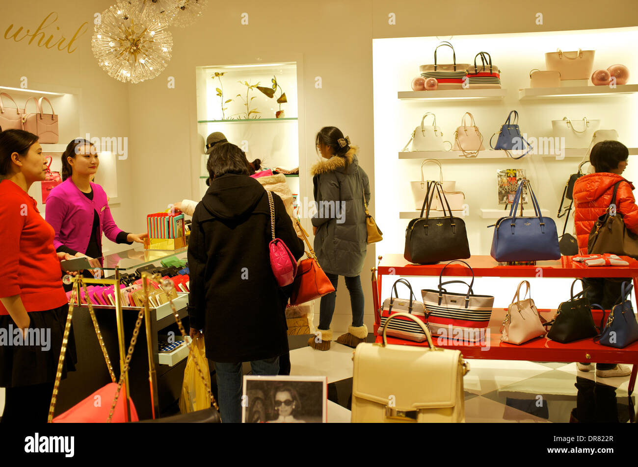 Chinese customers shop at a newly opened Kate Spade store in Sanlitun ...