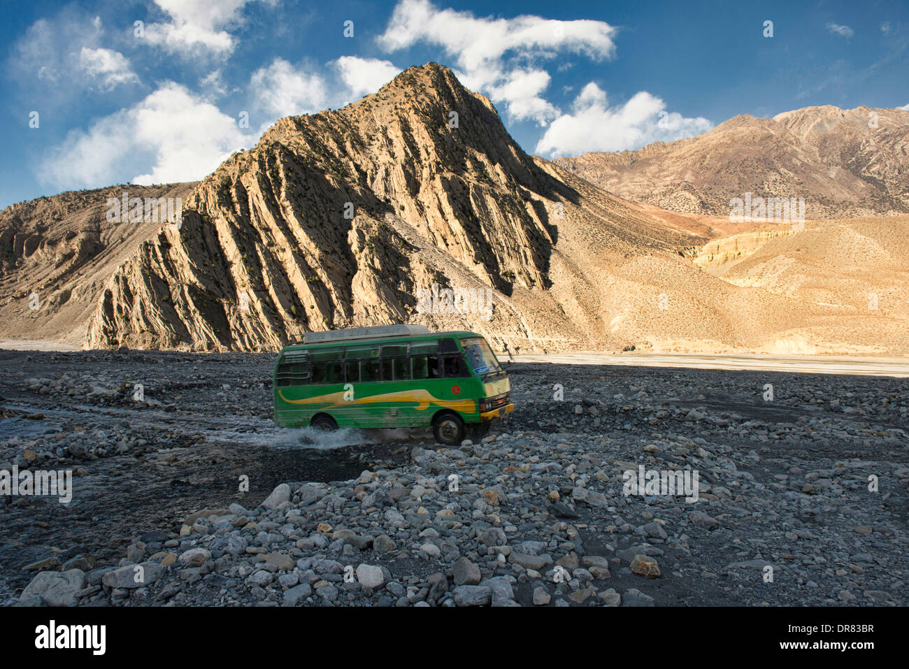 a bus travels up the Kali Gandaki River in the Annapurna region of ...