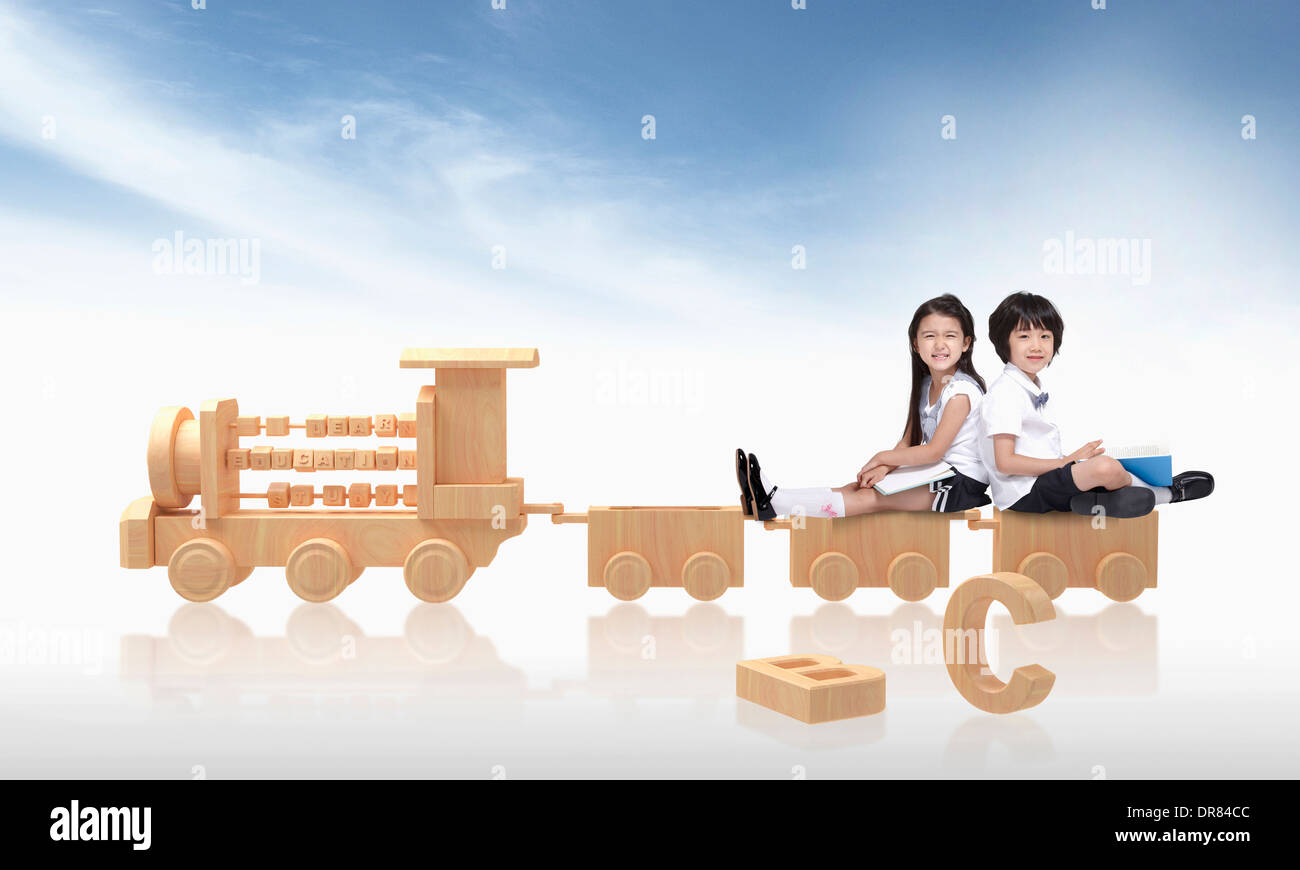 kids sitting on wooden train Stock Photo - Alamy