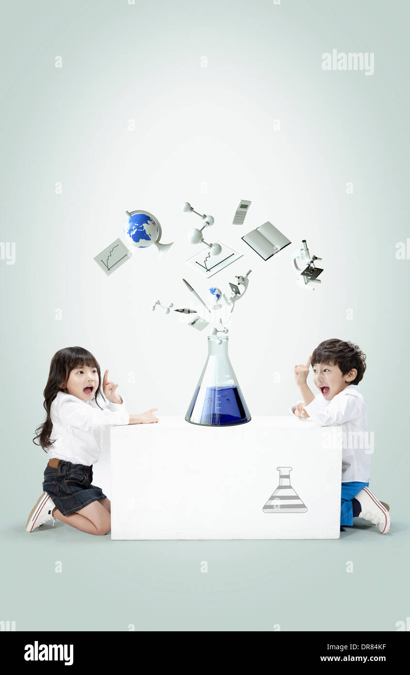a boy and a girl looking at a science lab tools Stock Photo - Alamy