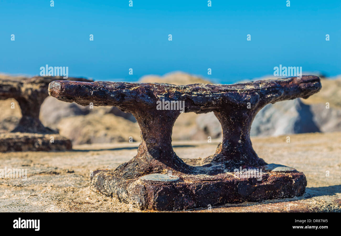 A large old rusty boat dock cleat Stock Photo - Alamy