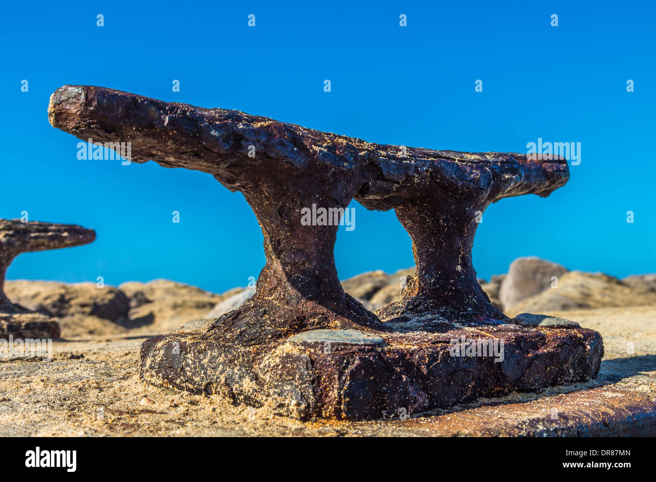 A large old rusty boat dock cleat Stock Photo - Alamy