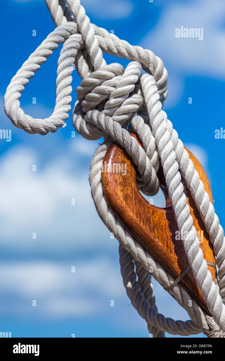 A wooden deadeye with rope on a sailing vessel Stock Photo - Alamy