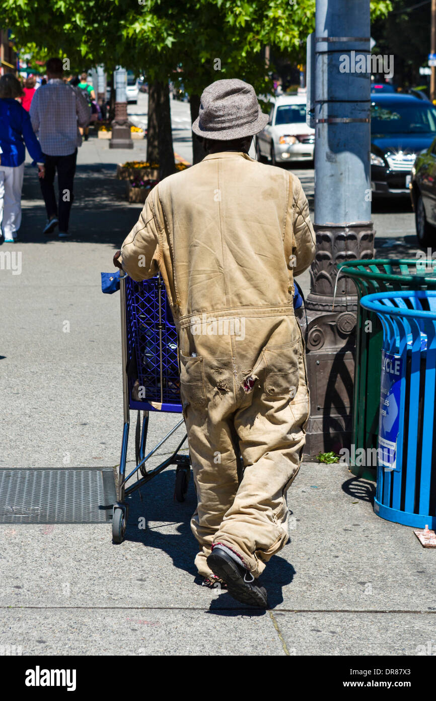Homeless man with a shopping cart on Alaskan Way in downtown Seattle ...