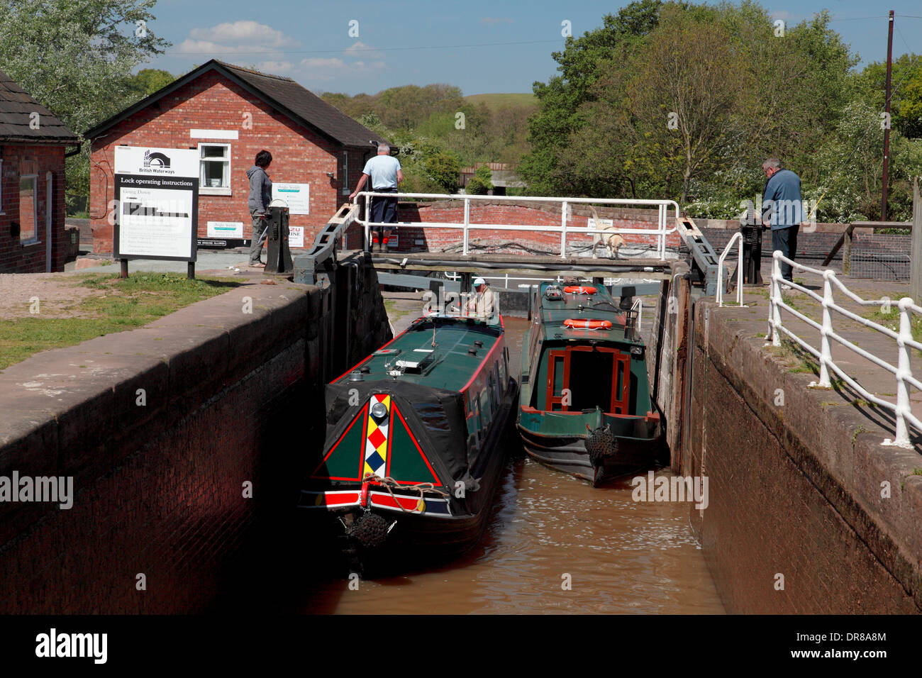 Two narrowboats entering the top lock of the staircase locks at Bunbury ...