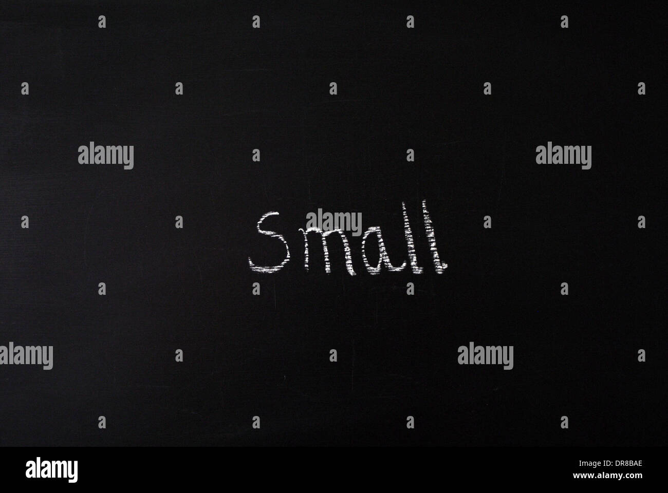 chalk writing - Small . - words written on blackboard Stock Photo - Alamy