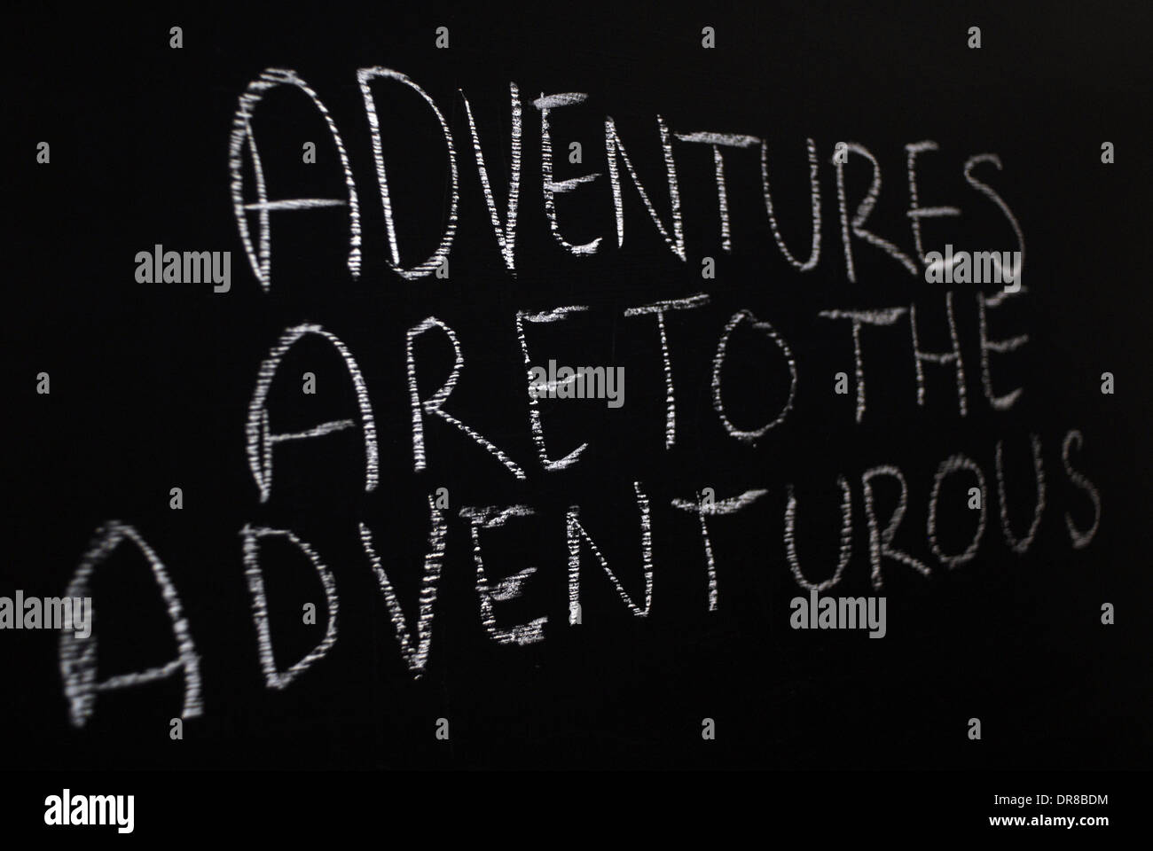 chalk writing - adventures are to the adventurous. - words written on ...