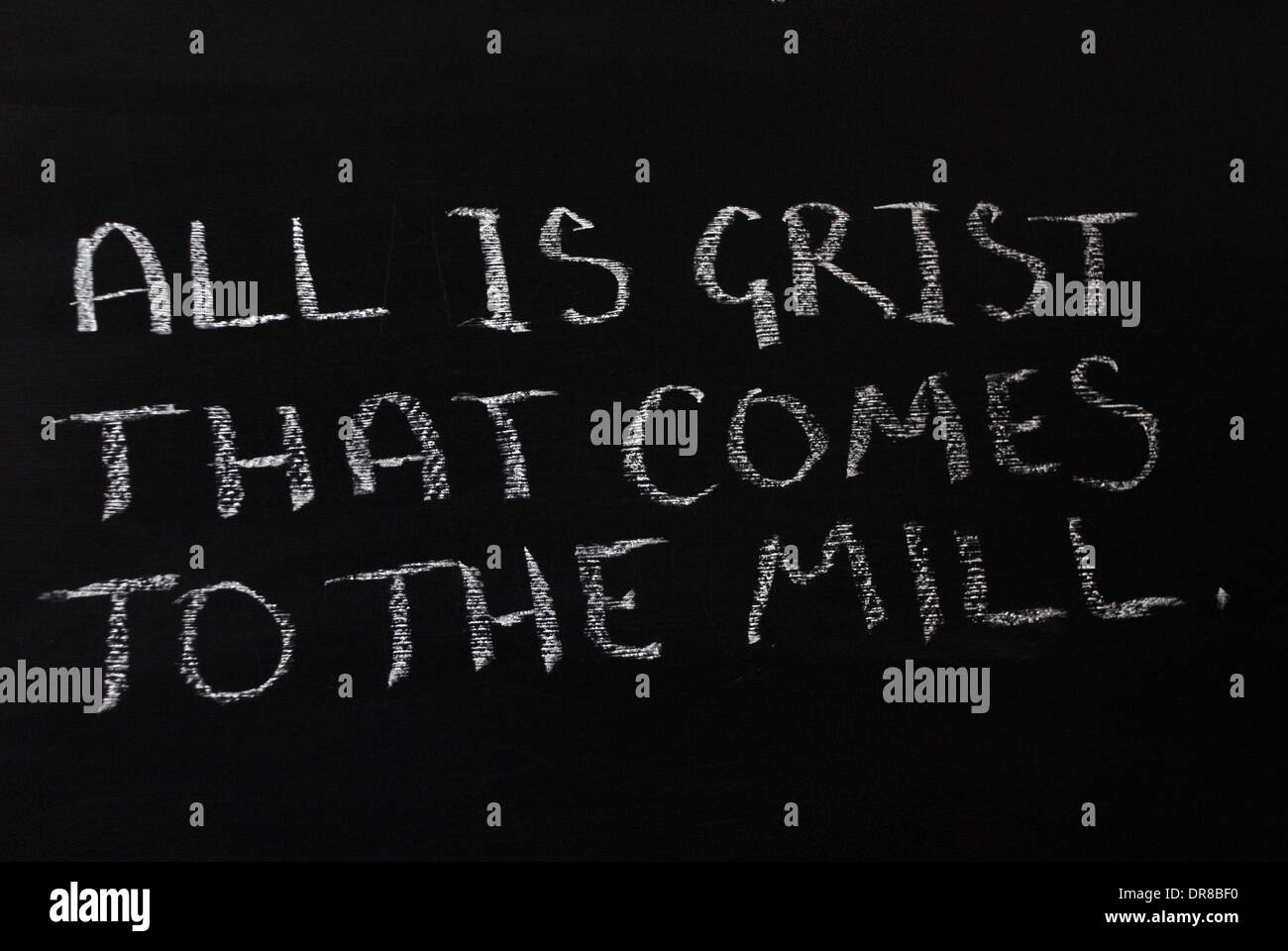chalk writing - All is grist that comes to the mill.- words written on ...