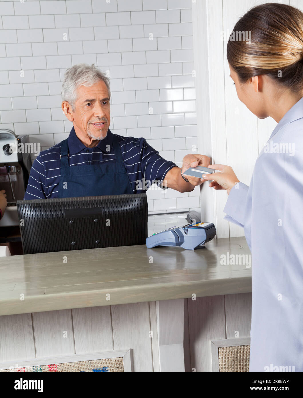 Customer Giving Credit Card To Cashier At Store Stock Photo - Alamy