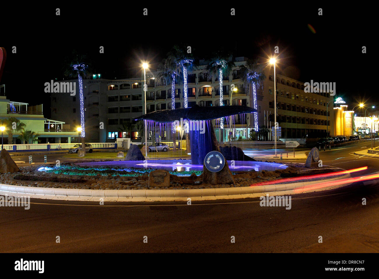 A sculpture of a whale's tail and water pool, on a roundabout, shot at ...