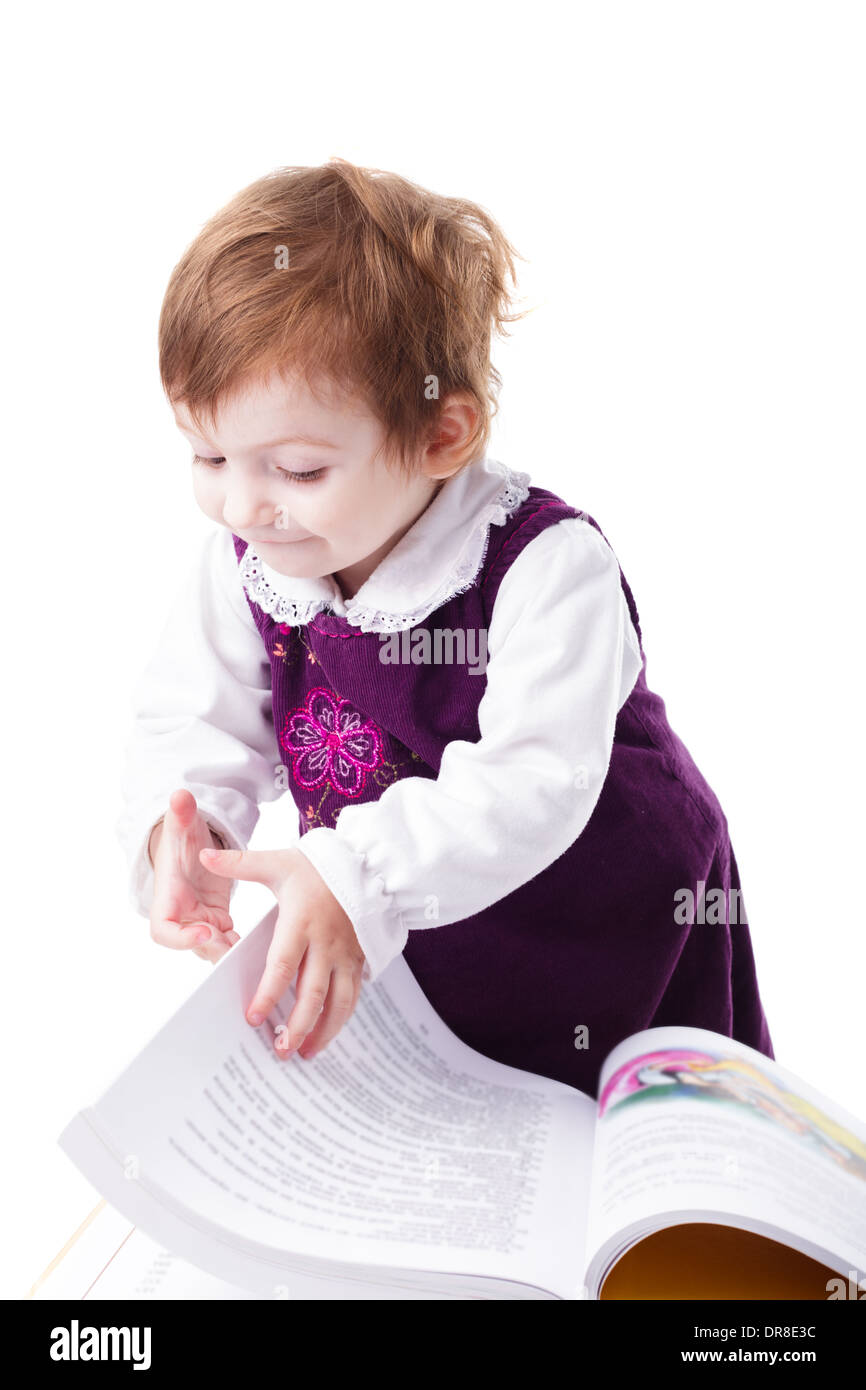 Little girl is looking in book and try to read, isolated on white Stock ...