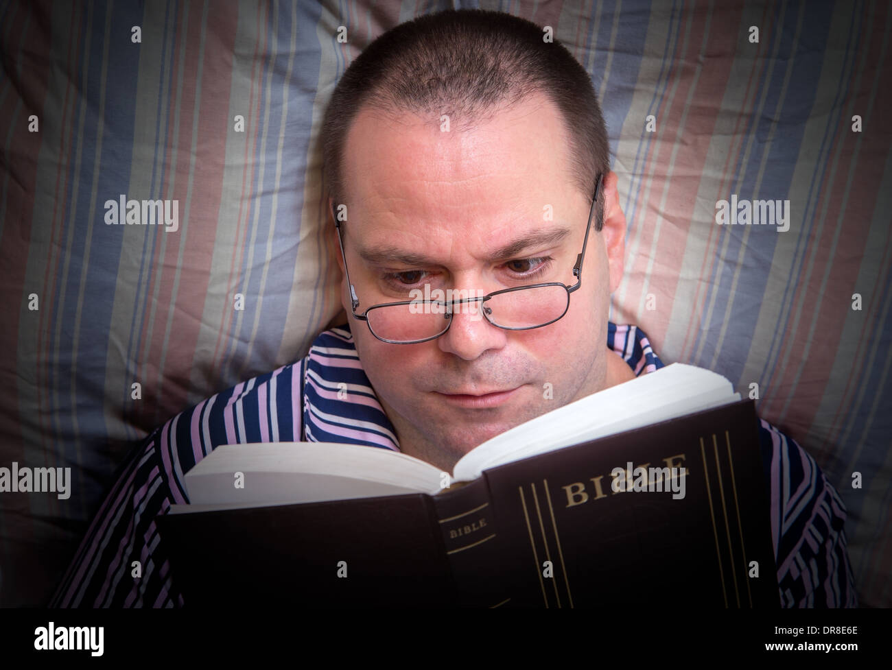 man reading the Bible in bed Stock Photo - Alamy