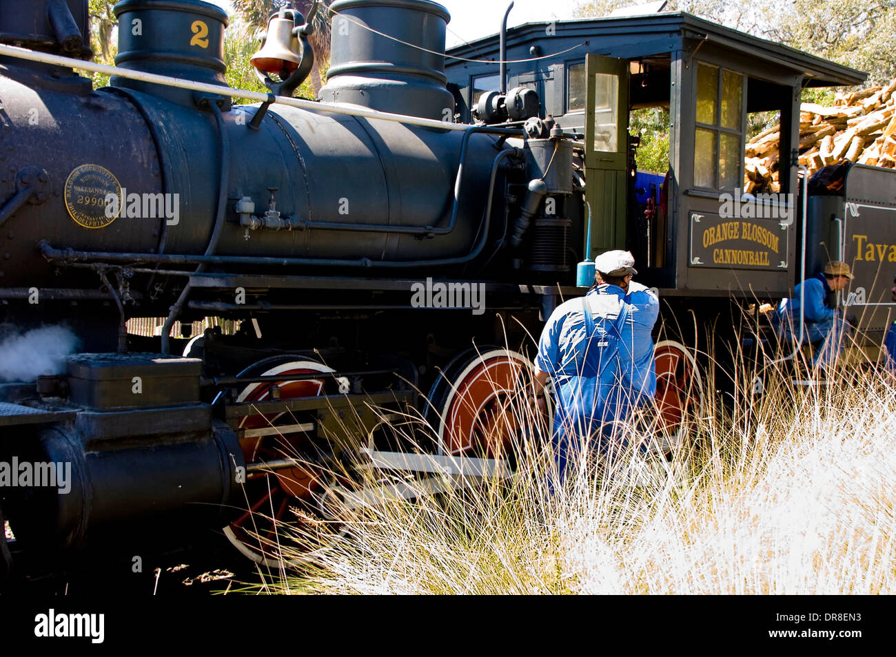 Steam train with workers Stock Photo - Alamy