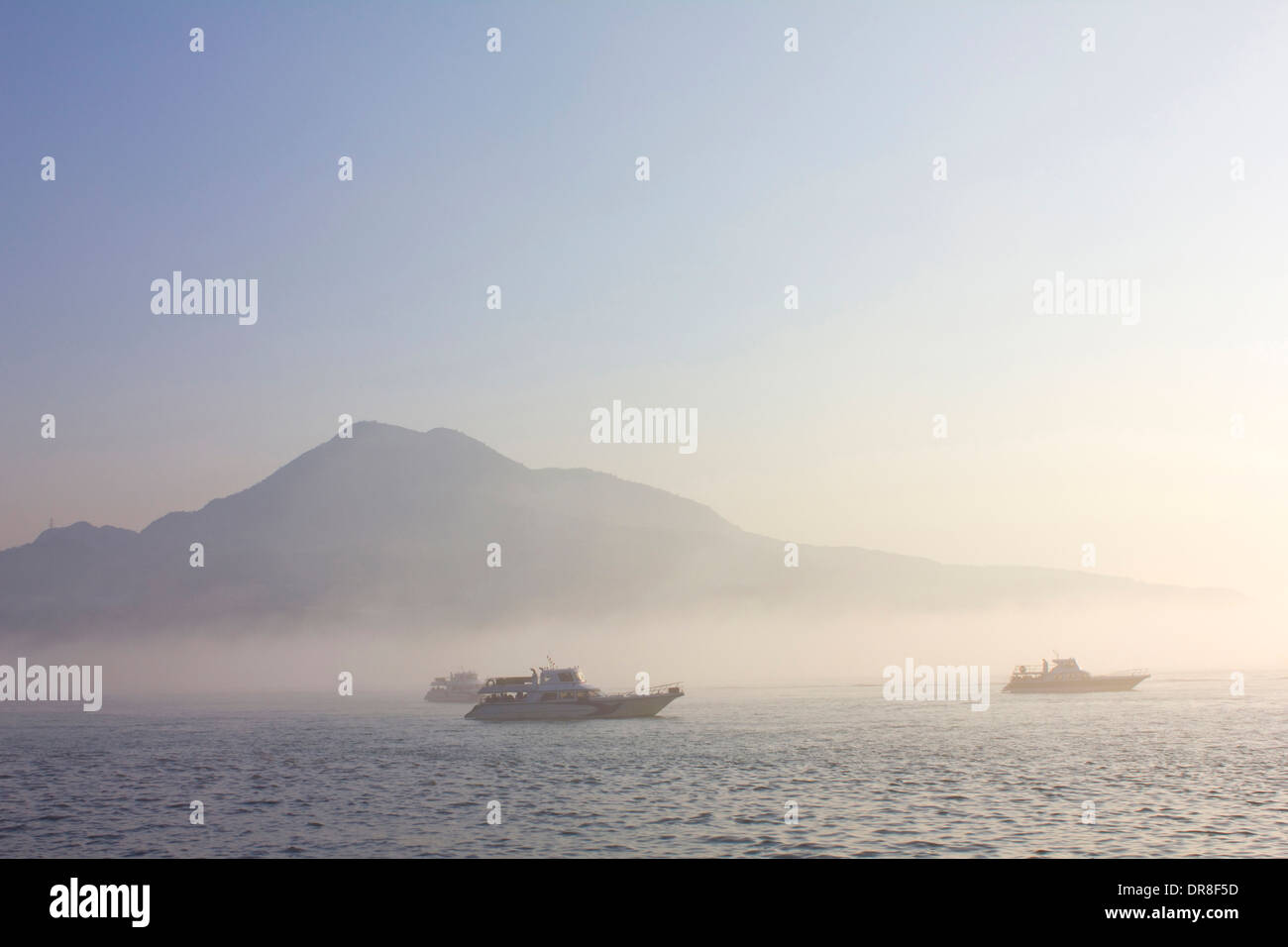 Boats passing on river Stock Photo - Alamy