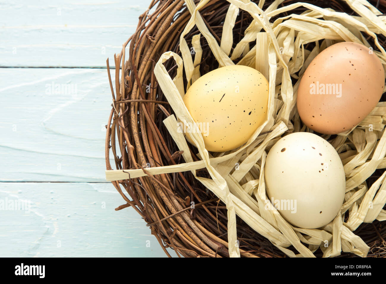 Three colored, spotted eggs in a nest Stock Photo - Alamy