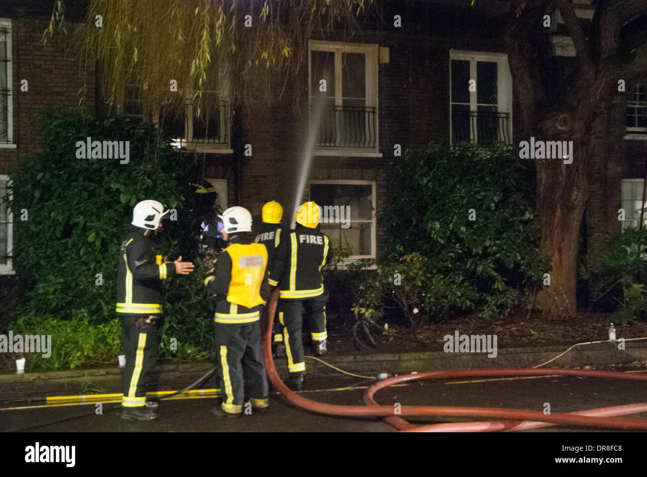 London, UK . 21st Jan, 2014. London Fire Service crew tackle a house ...