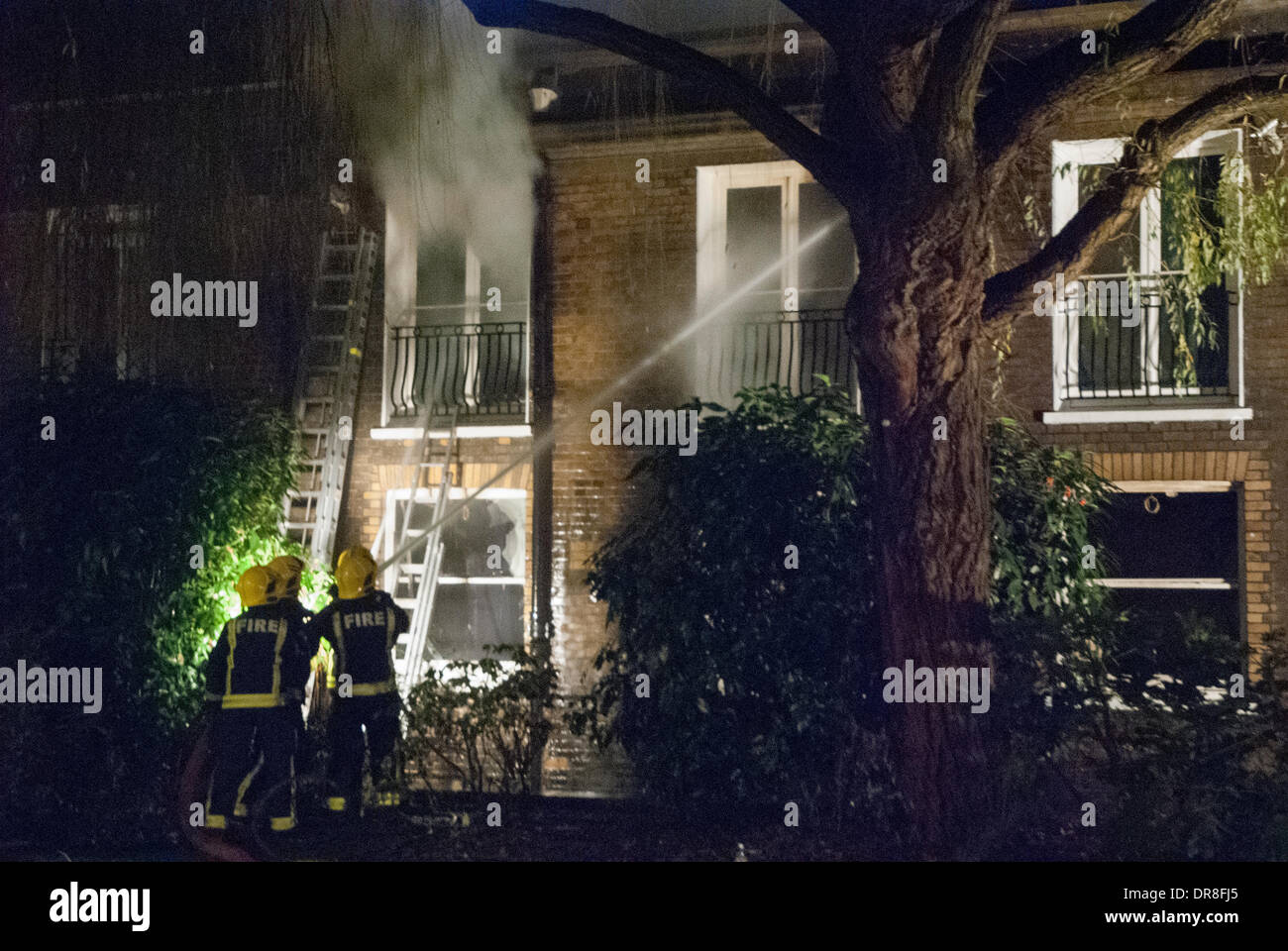 London, UK . 21st Jan, 2014. London Fire Service crew tackle a house ...