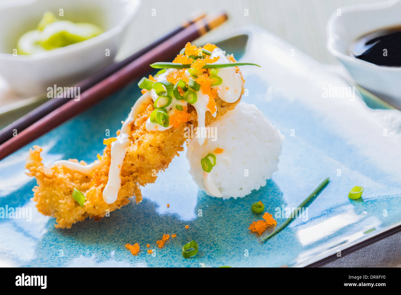 Fried breaded ahi tuna on a ball of rice, drizzled with masago ...