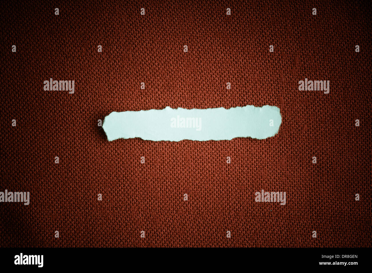 Piece scrap of white paper blank copy space on red fabric textile ...