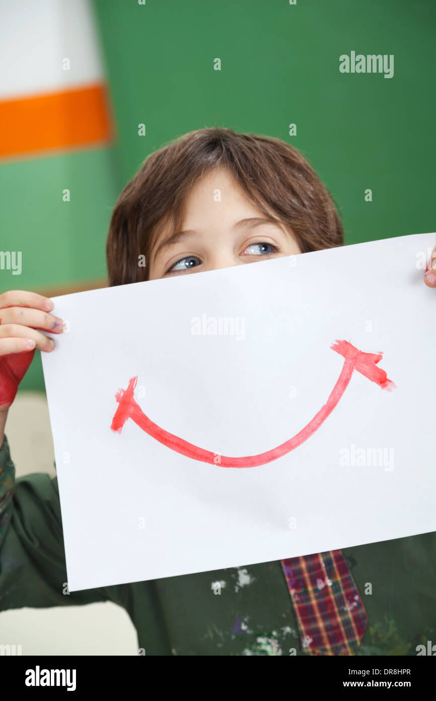 Boy Holding Paper With Smile Drawn On It Stock Photo - Alamy