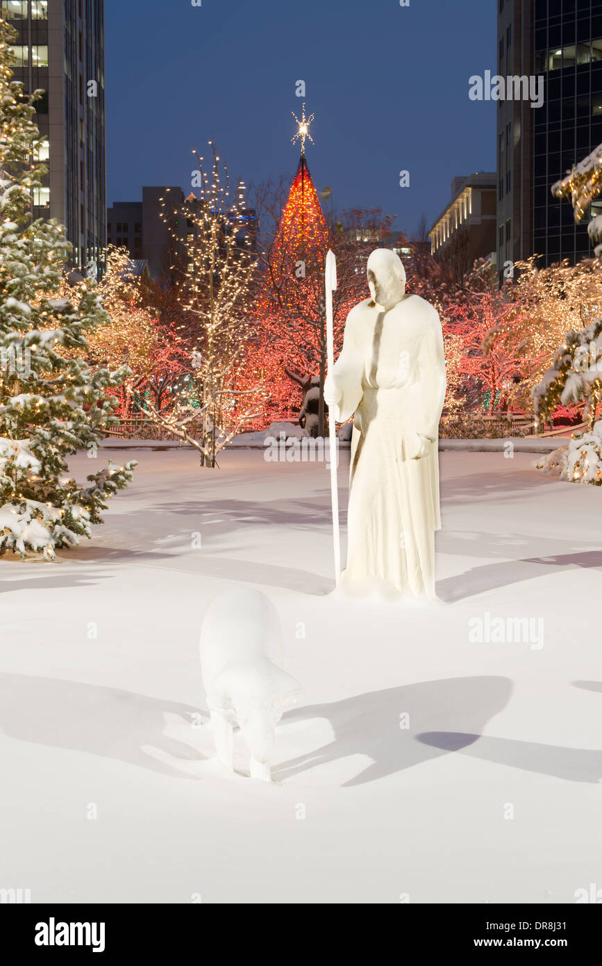 Statues of Jesus Christ and sheep in snow in Temple Square at night ...
