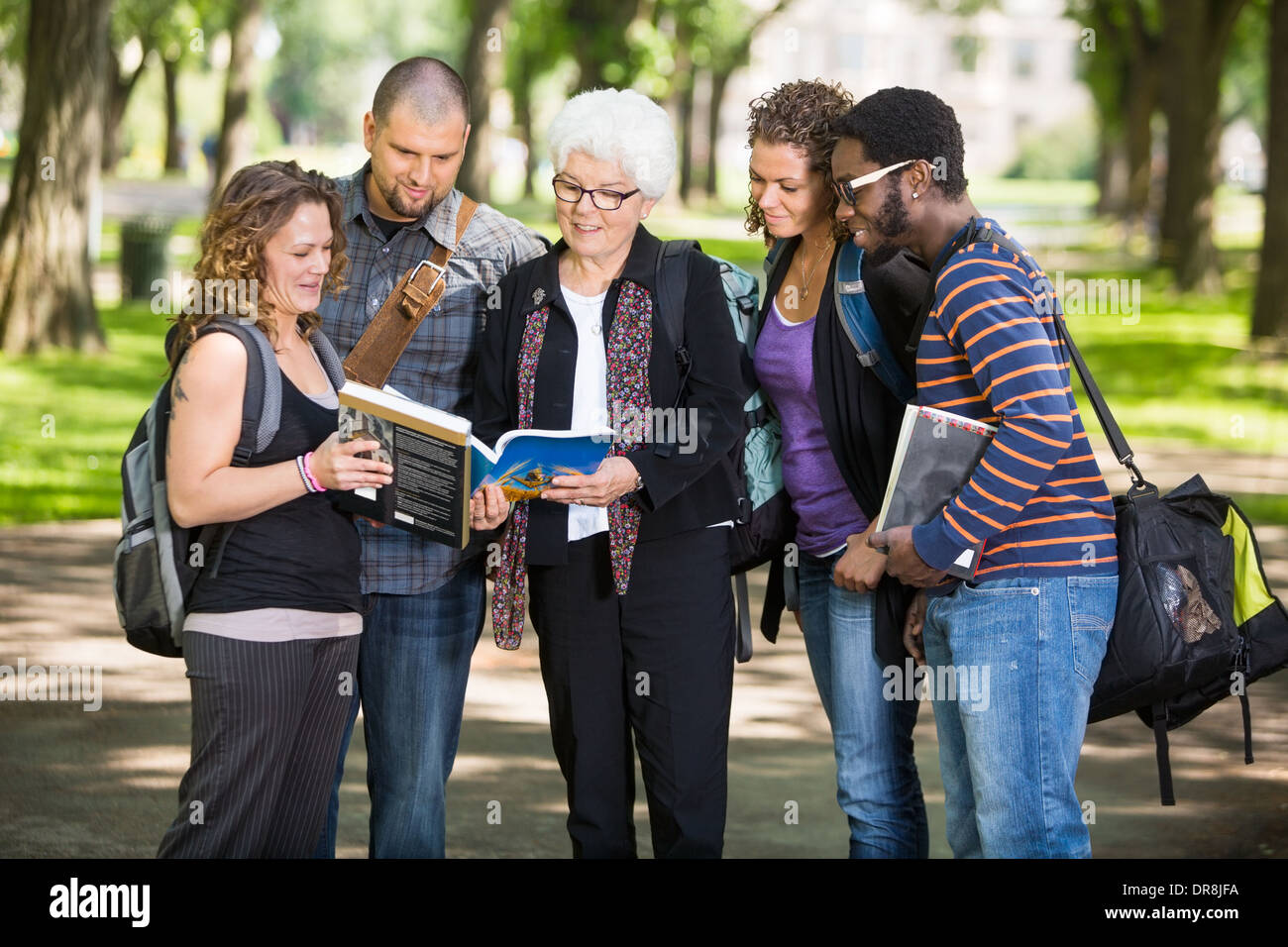 Senior Student Discussing Notes With Classmates On Campus Stock Photo ...