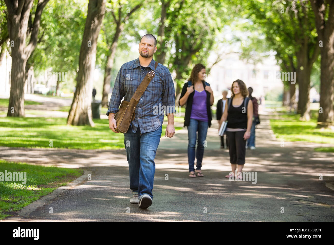 Confident Male Grad Student Walking On Campus Stock Photo - Alamy