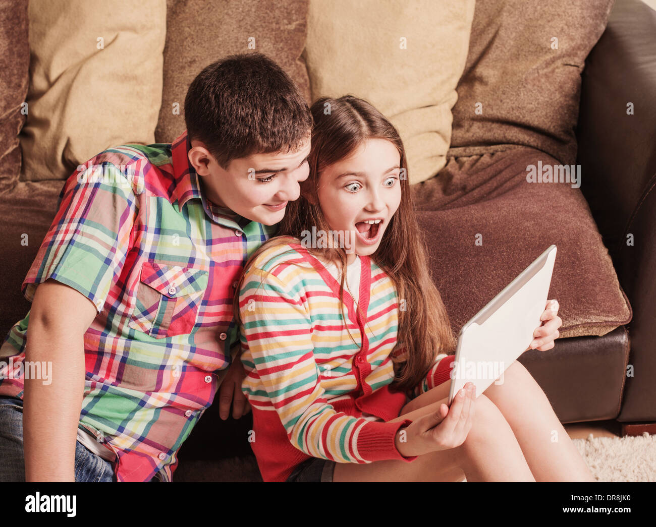 teenagers using electronic tablet at home Stock Photo - Alamy