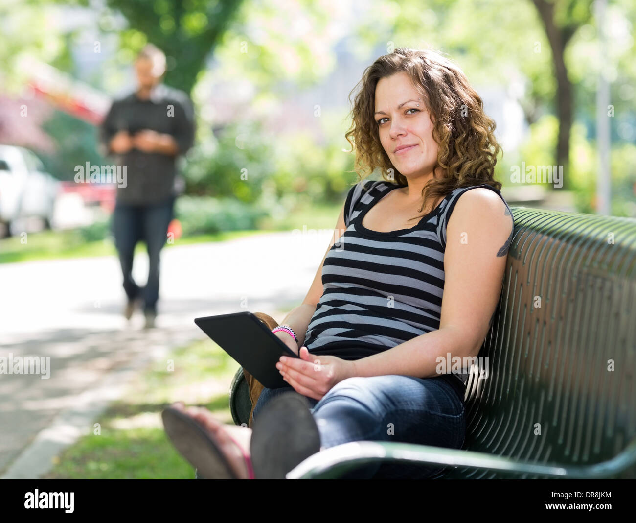 Student Relaxing On Bench At University Campus Stock Photo - Alamy