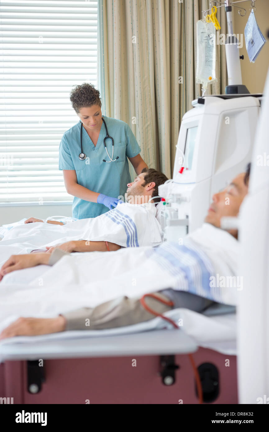 Nurse Looking At Patient Undergoing Renal Dialysis Stock Photo - Alamy
