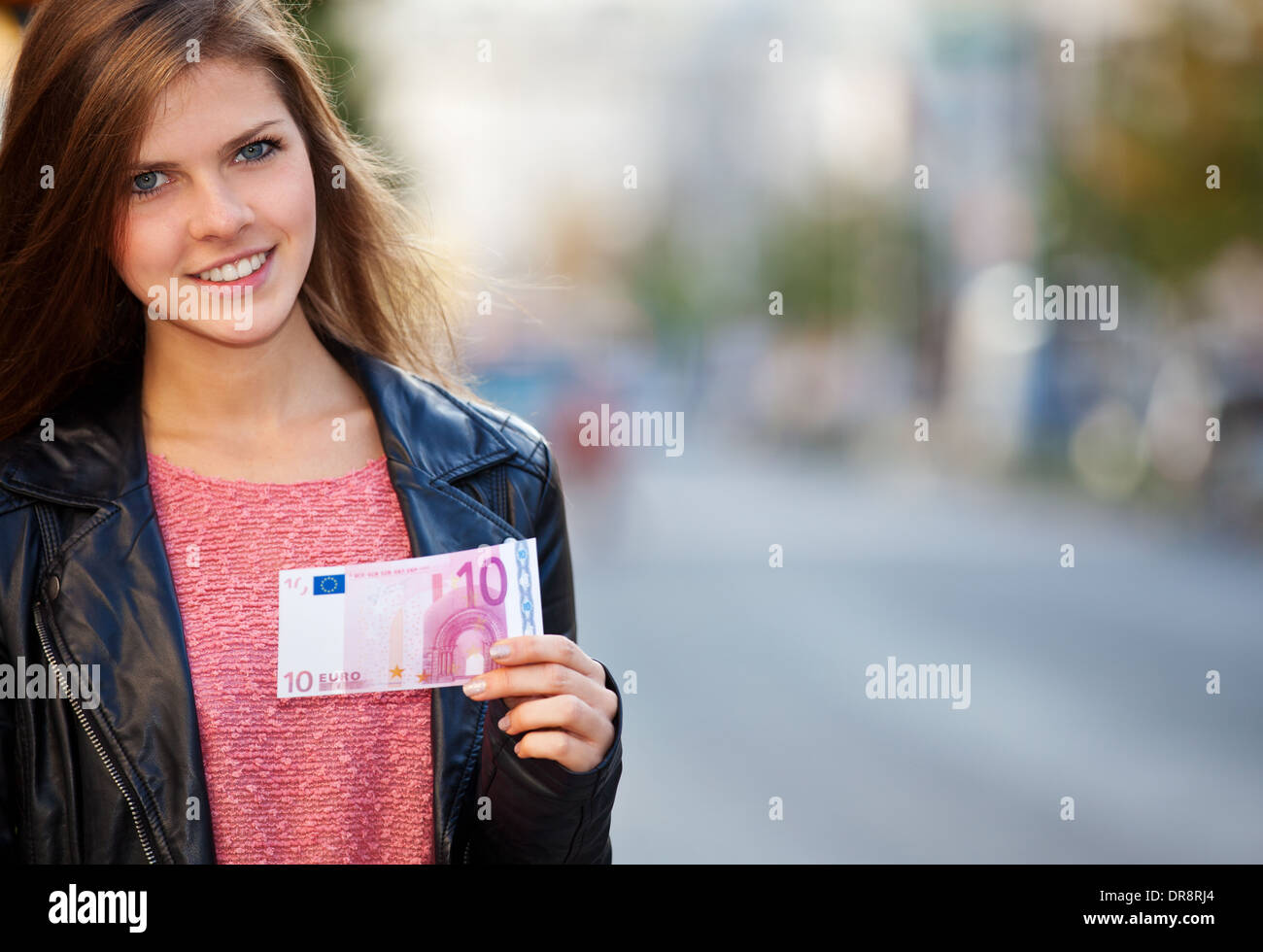 Attractive girl holding 10 euro Stock Photo - Alamy