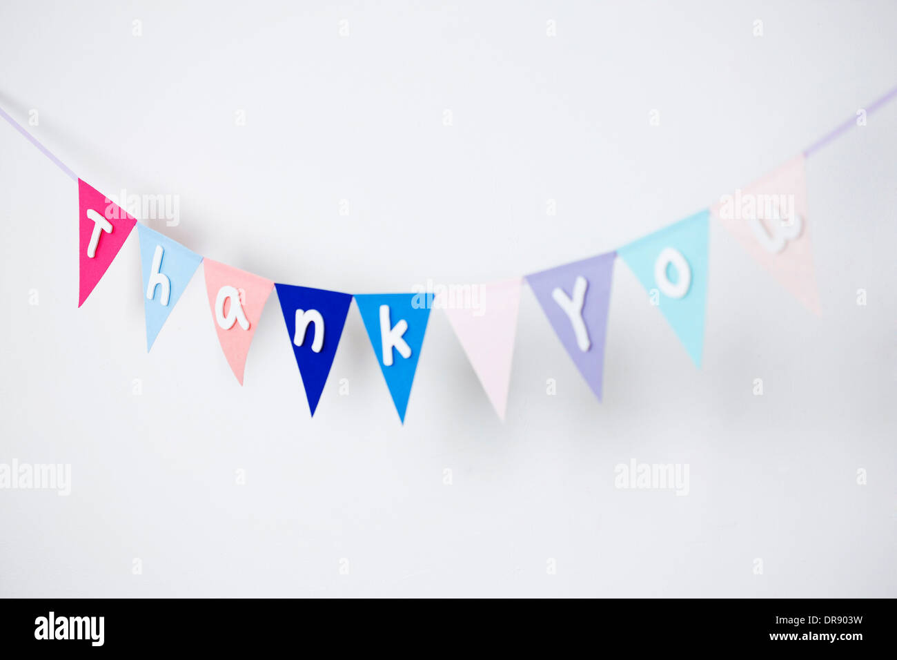 flags hanging in the string saying thank you Stock Photo - Alamy