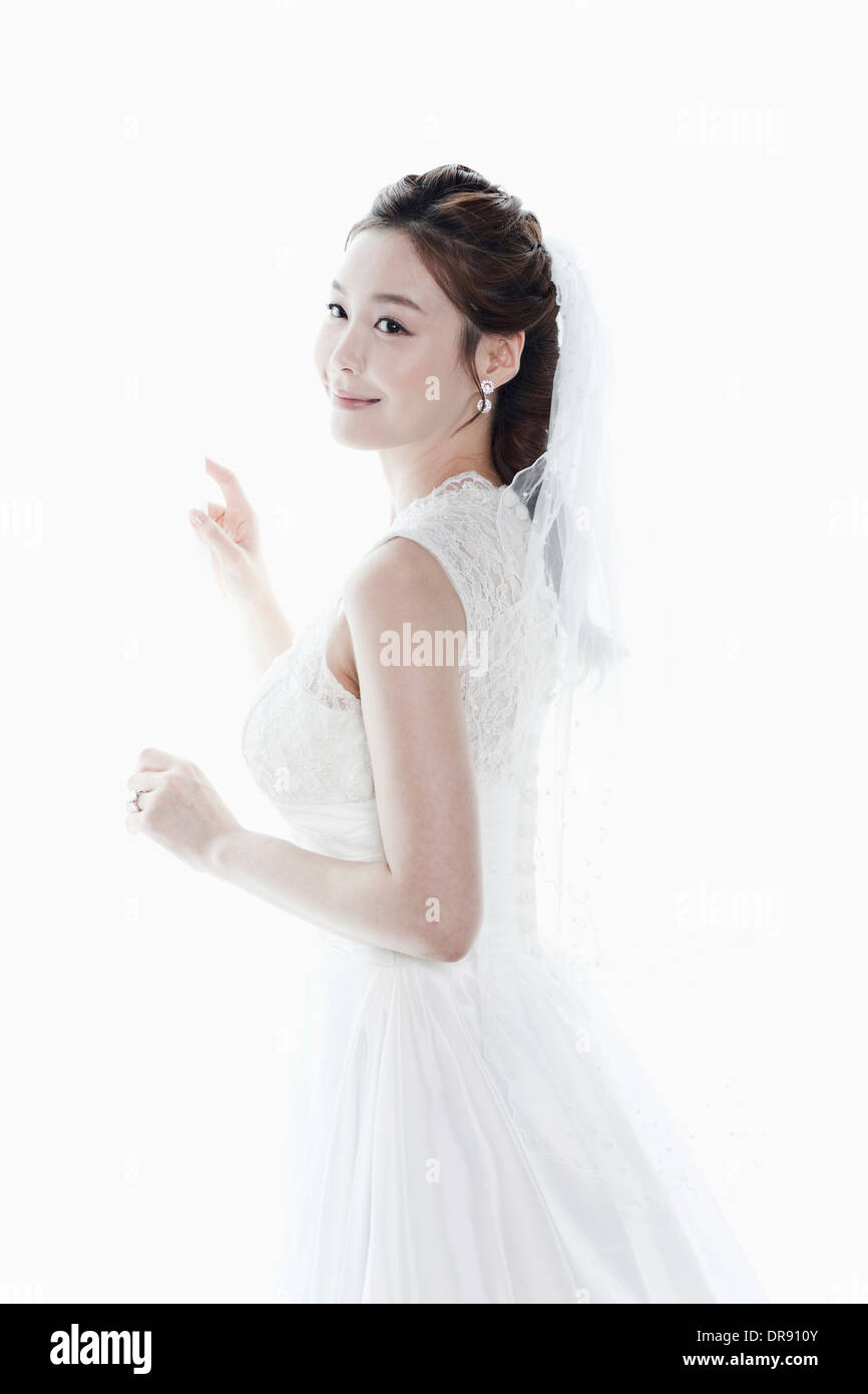 a woman in wedding dress in white background Stock Photo - Alamy