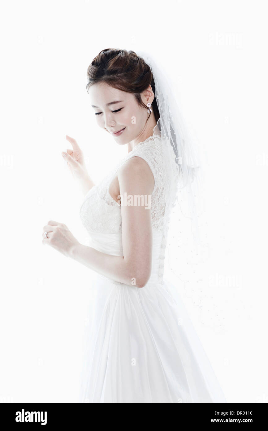 a woman in wedding dress in white background Stock Photo - Alamy