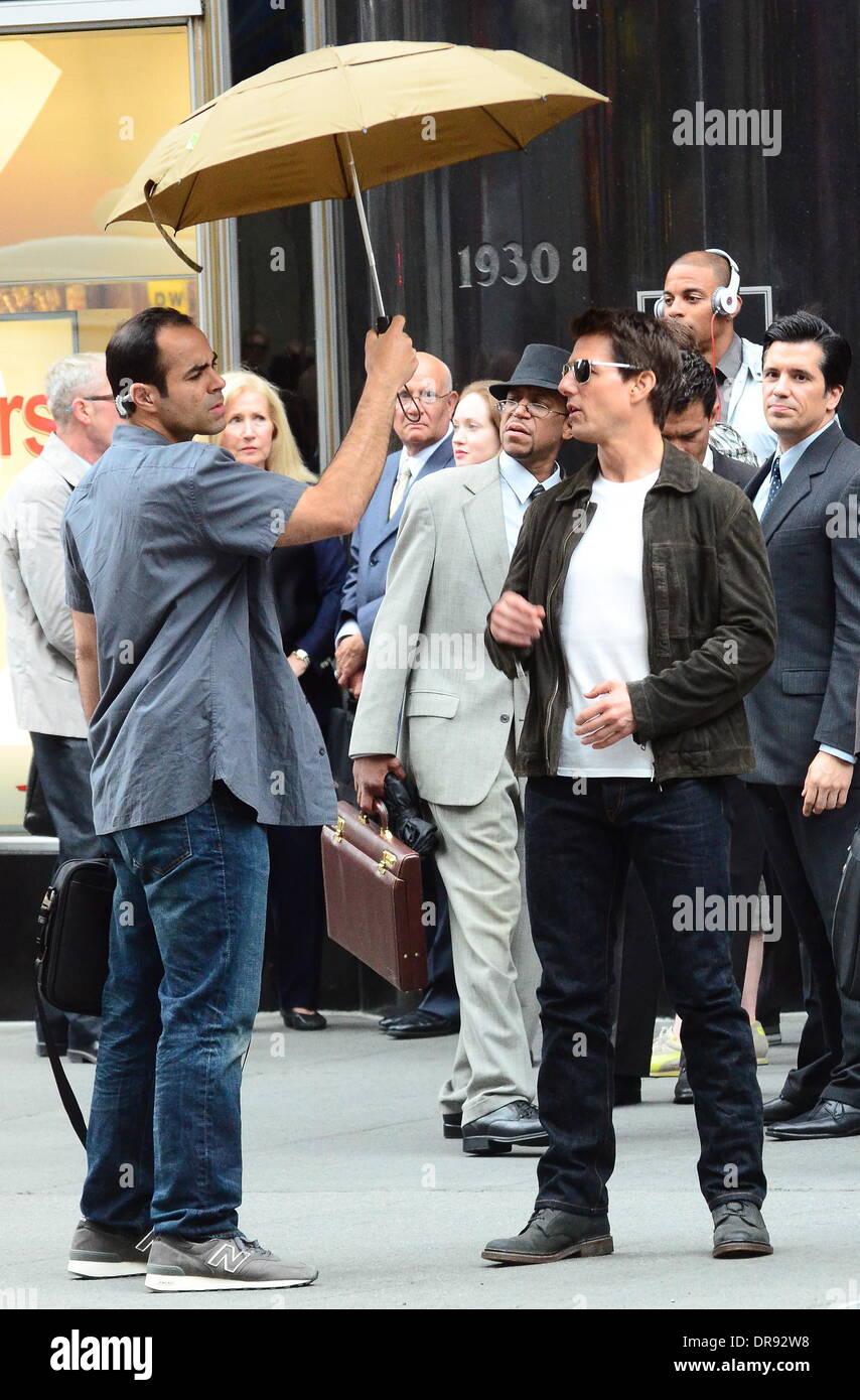 Tom Cruise gets caught in the rain while filming on the set of ...