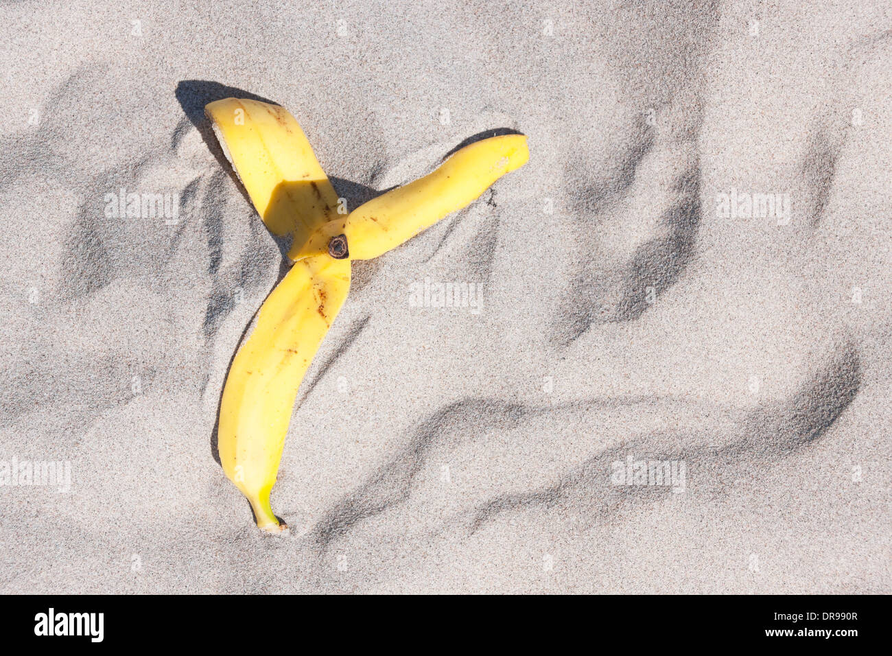 Banana peel on sand Stock Photo - Alamy