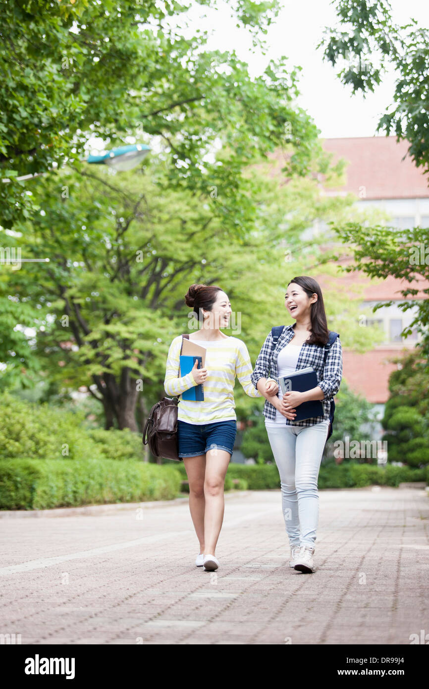 university students walking in the campus talking Stock Photo - Alamy